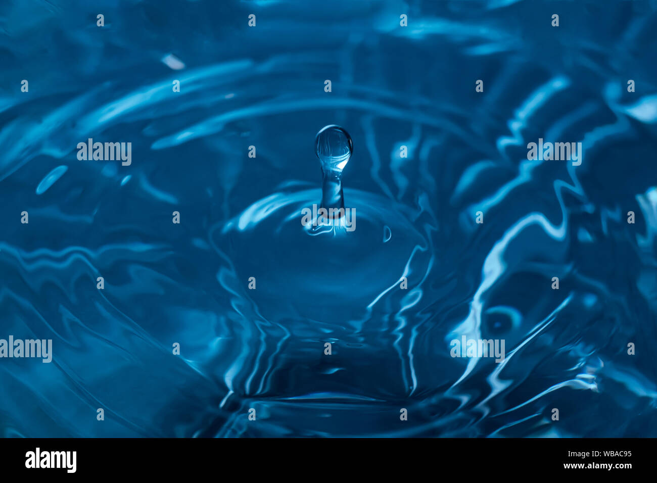 Drop of water. Blue water drop. Falling water. Water splash close-up ...