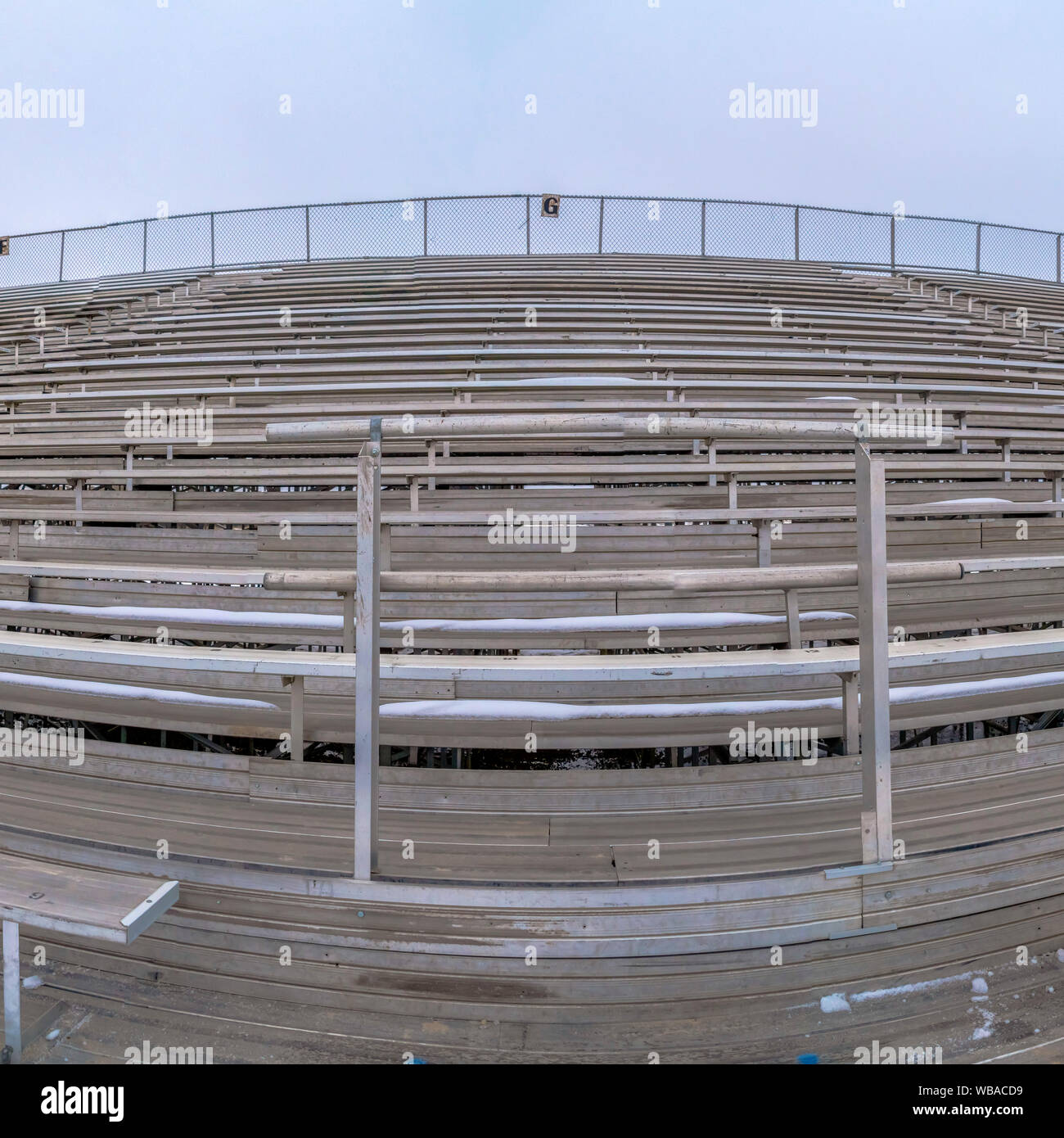 Square Tiered seating at a sports arena under a cloud filled sky in ...