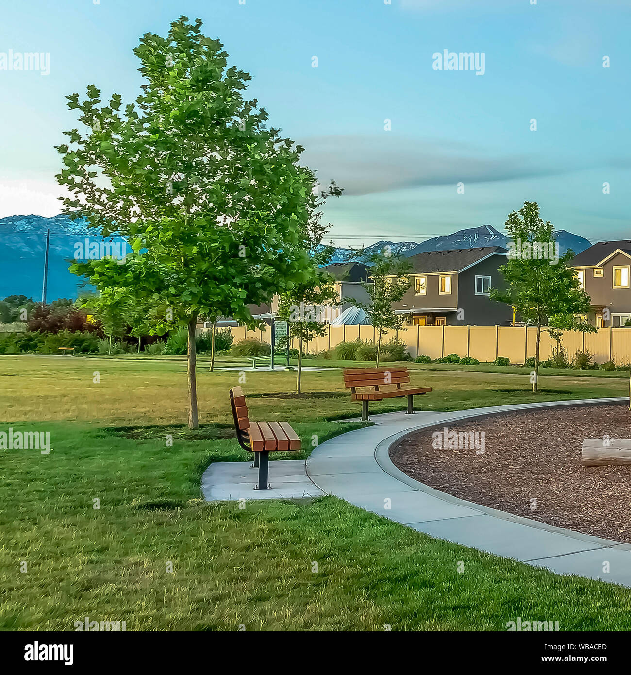 Square Neighborhood park with benches and pathway around a childrens ...