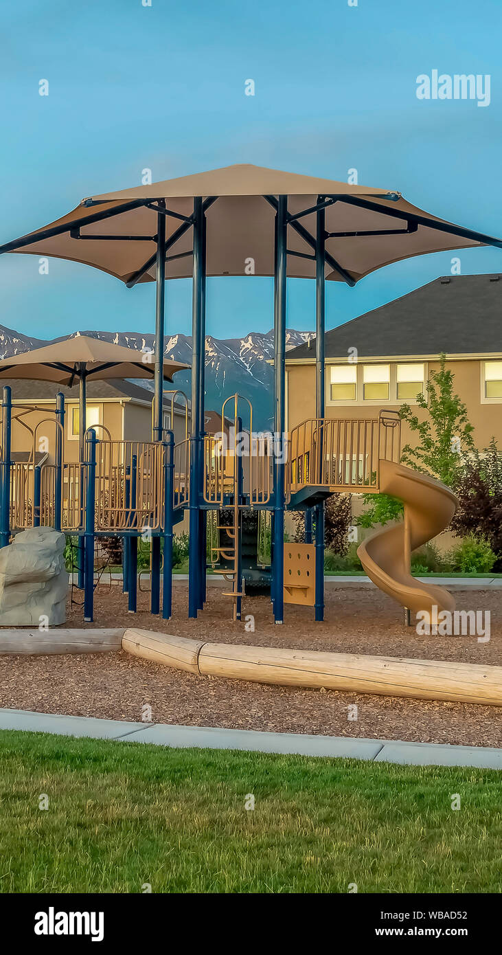 Vertical frame Park with playground and benches in front of multi ...