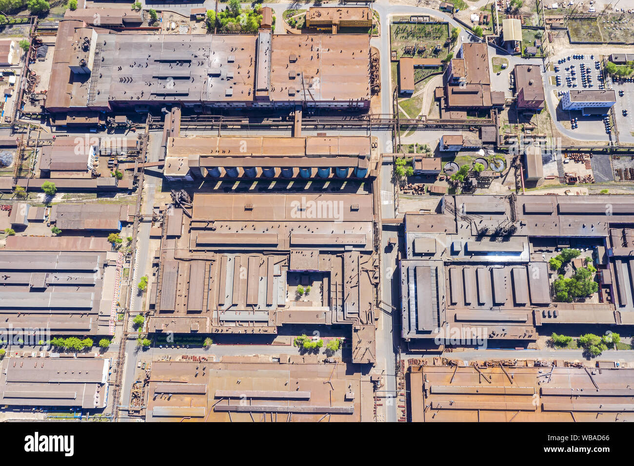 industrial zone at suburb area. drone image of rusty roofs of ...