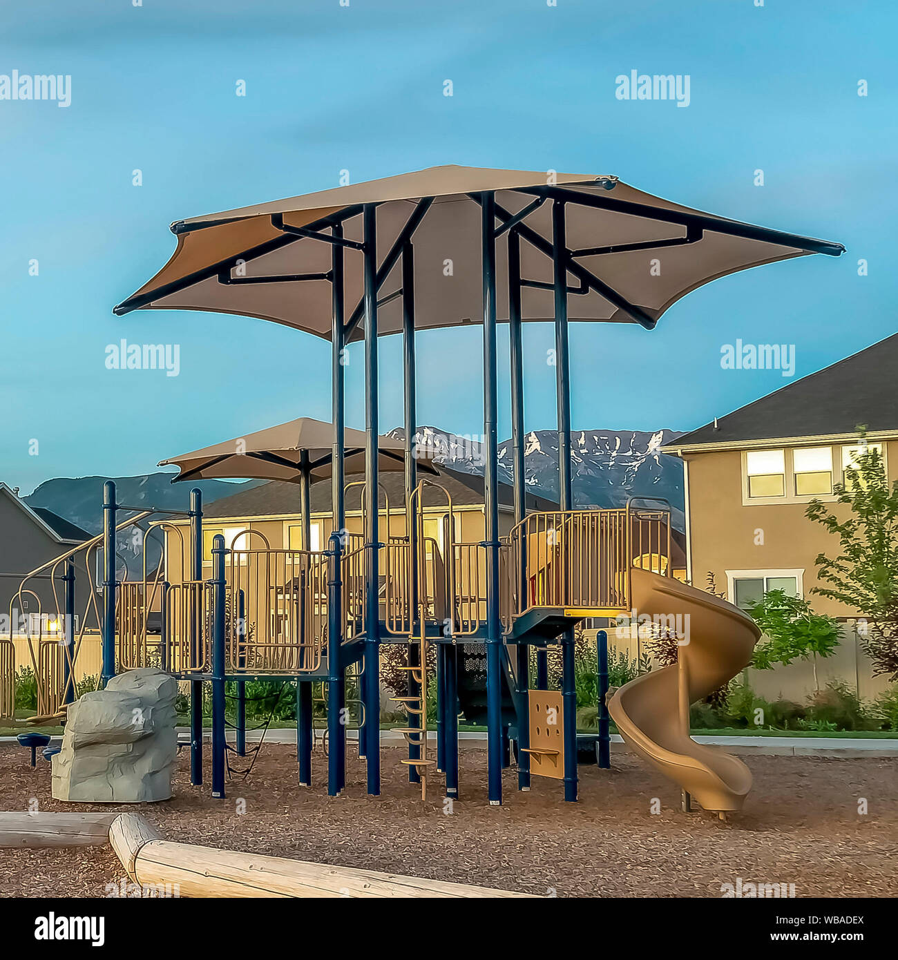 Square Neighborhood park with benches and pathway around a childrens ...