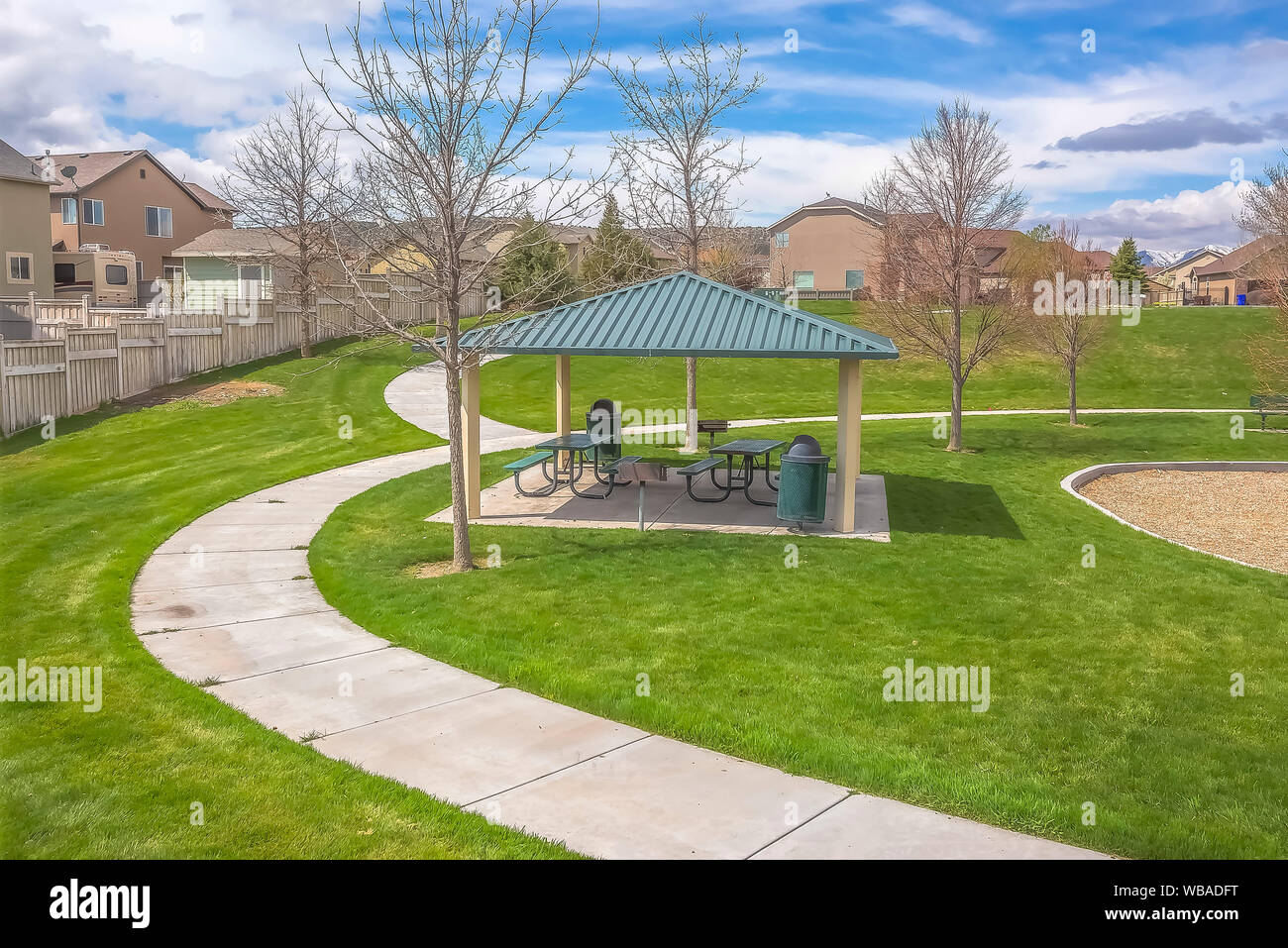Small picnic area and curving pathways on a park covered with vivid ...