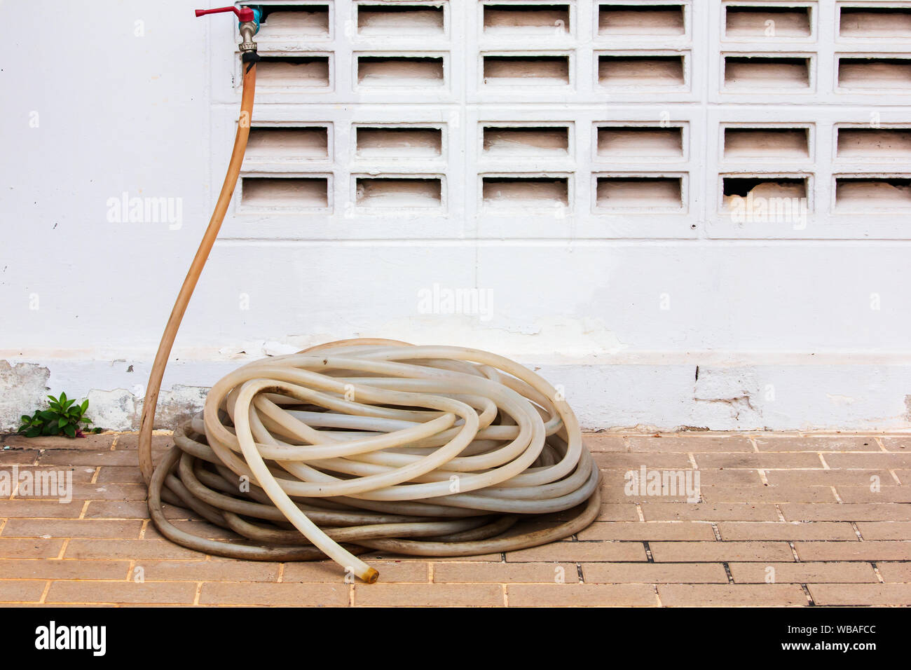 Old water hose on the floor background Stock Photo - Alamy