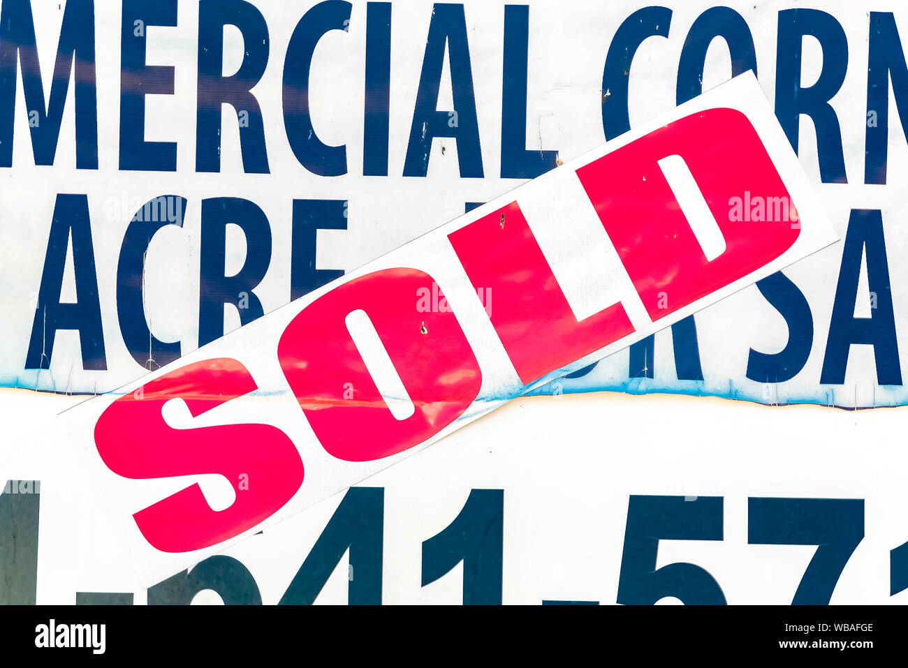 Close up of a Sold sticker on a real estate for sale sign viewed on a ...