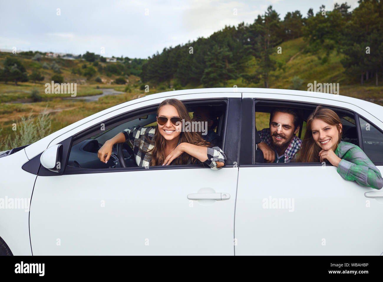 A group of happy friends are driving in a car Stock Photo - Alamy