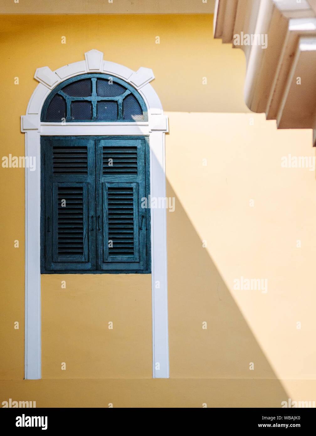 Old vintage green wooden window shutters with white frame on classic ...