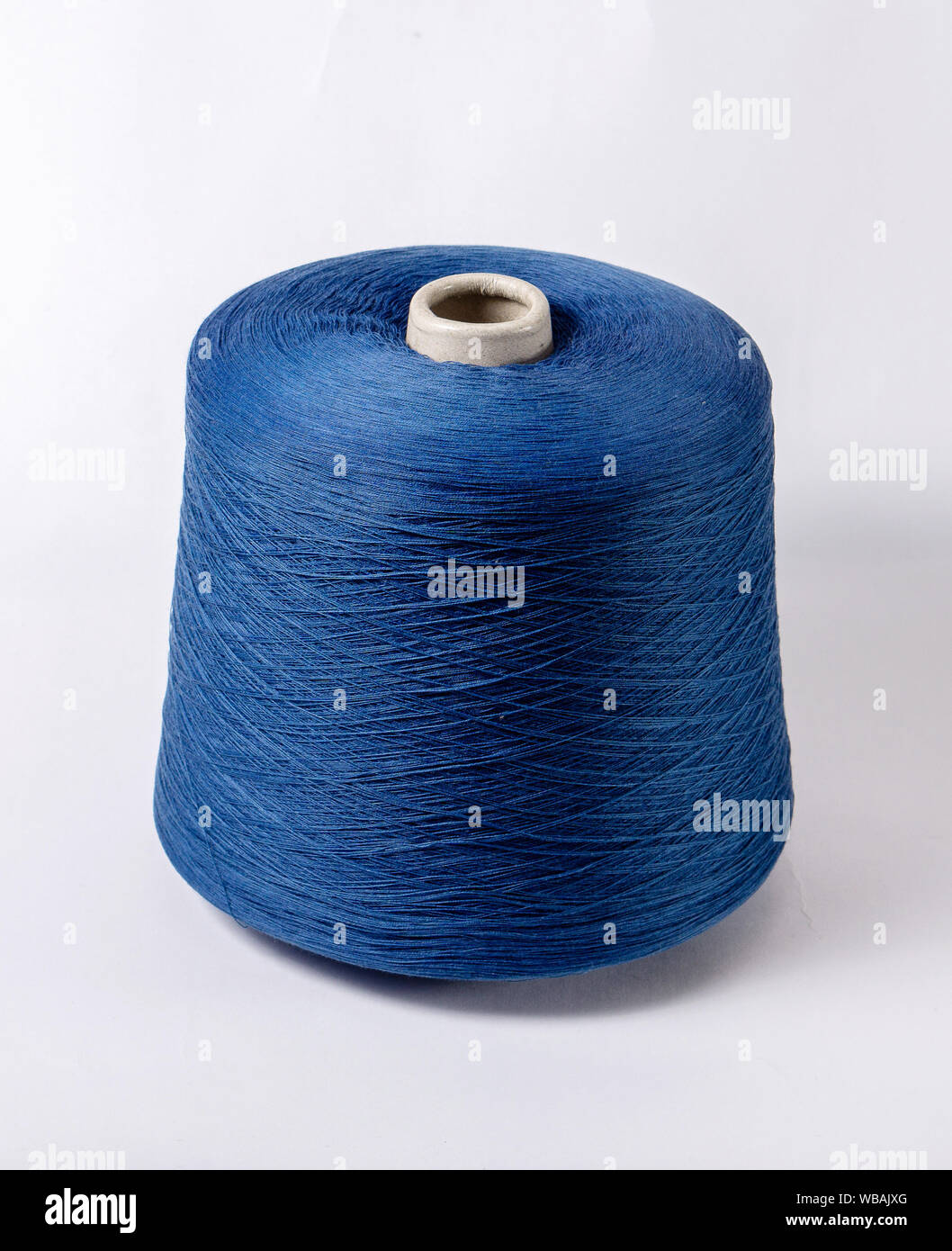 bobbin of yarn on a white background. Side view.Textile reel on ...