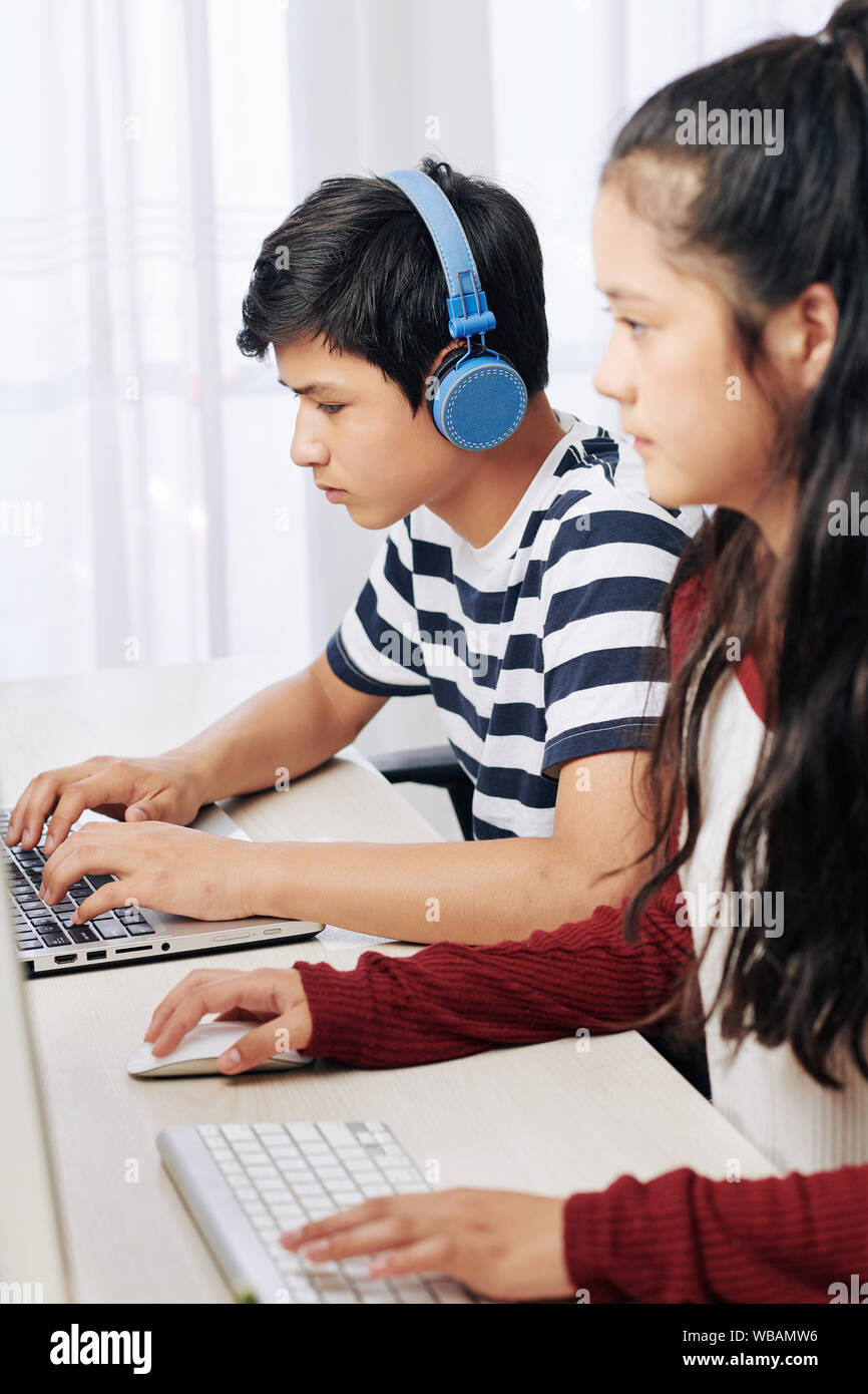 Child typing laptop in classroom hi-res stock photography and images ...