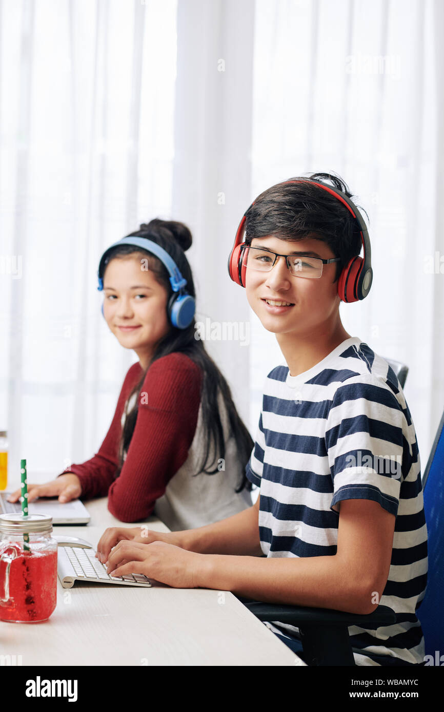 Smiling Asian boy and girl programing and working on project for school ...