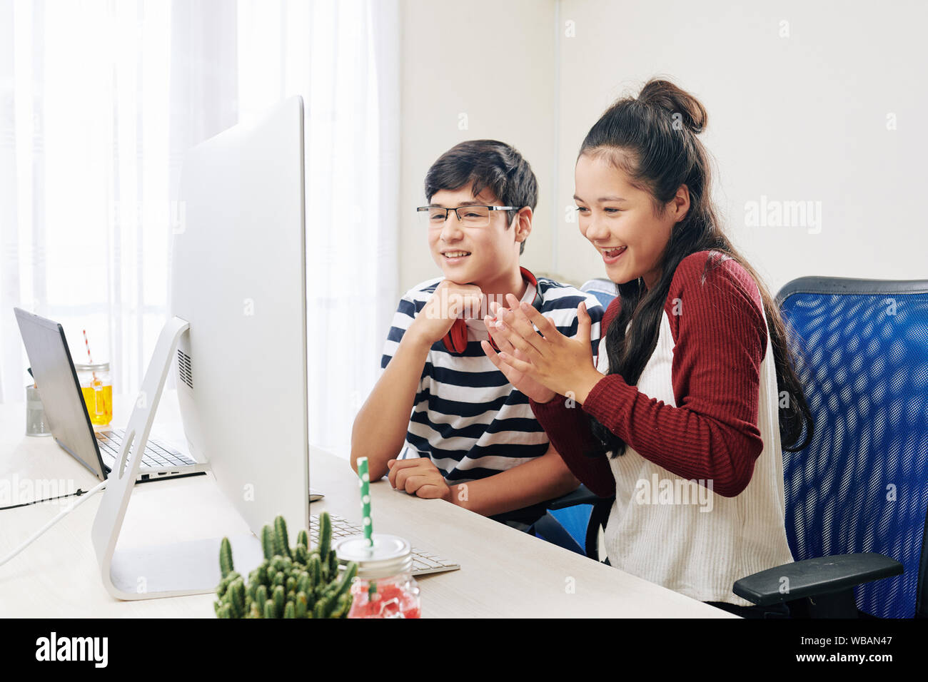 Happy excited mixed-race teenagers clapping when watching how the ...
