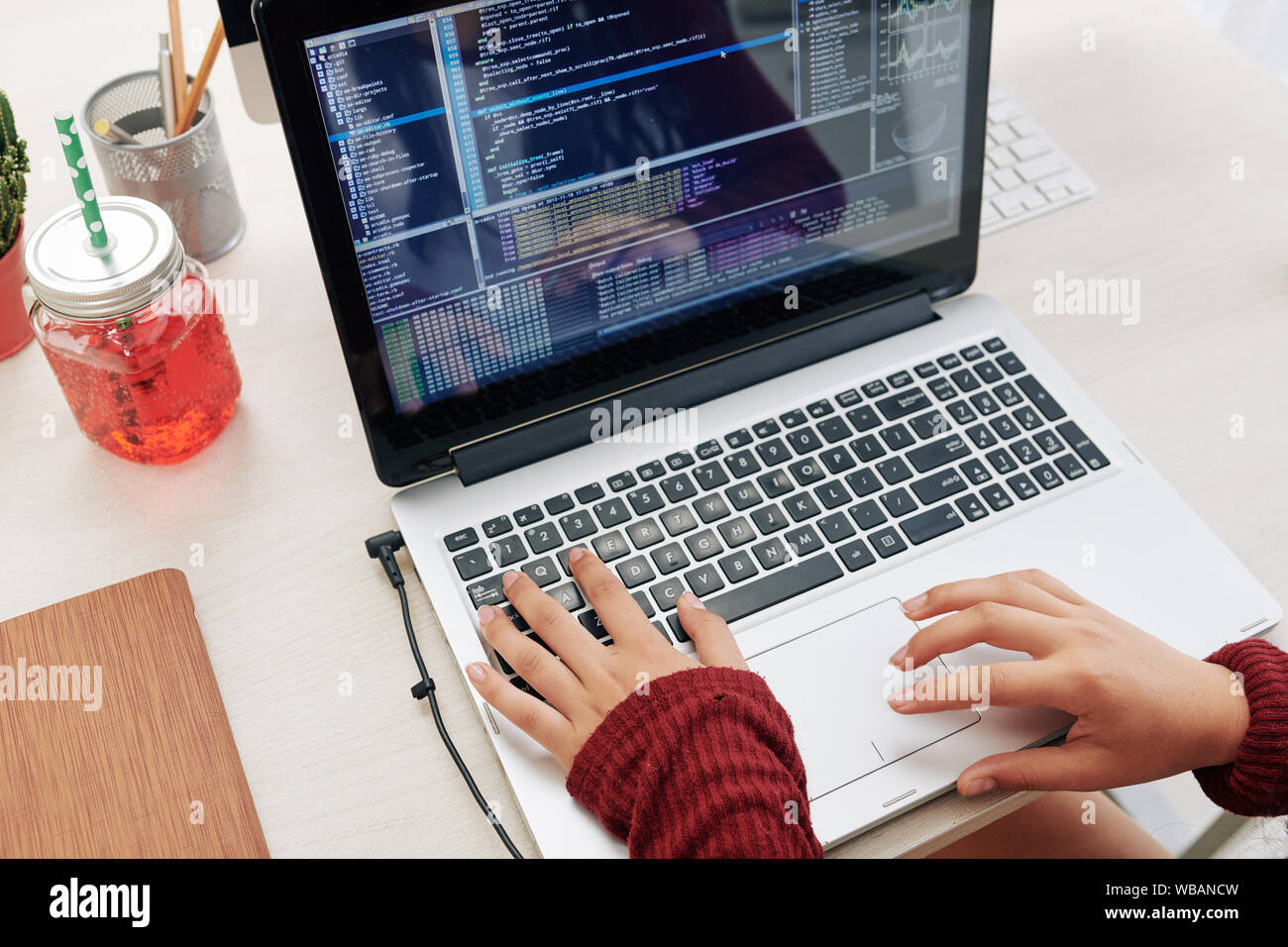 Hands of girl programming or testing new software on her laptop, view ...