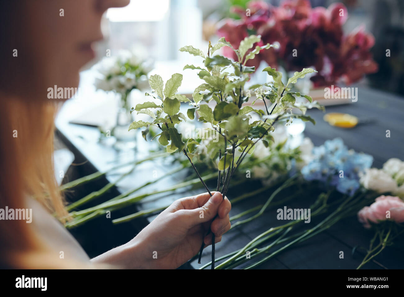 Adding greenery into bouquet for texture Stock Photo - Alamy