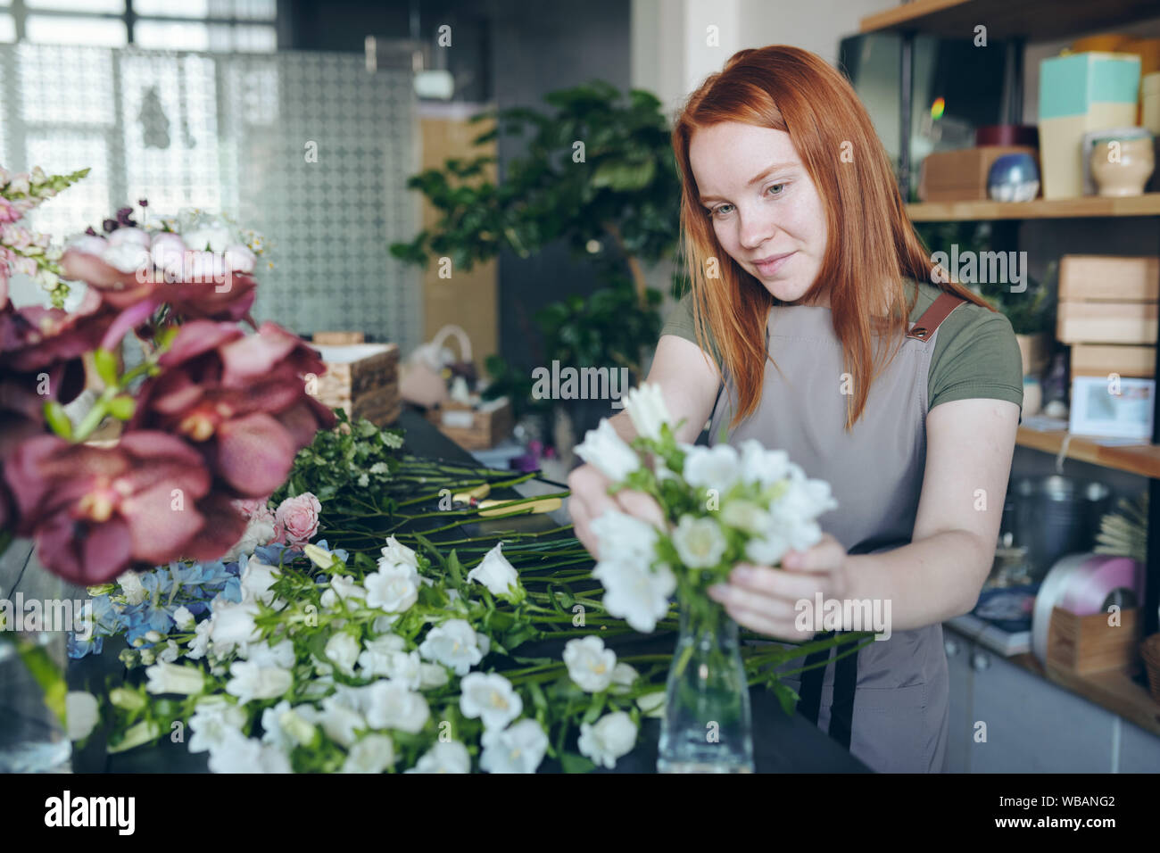 Cheerful florist in apron hi-res stock photography and images - Alamy
