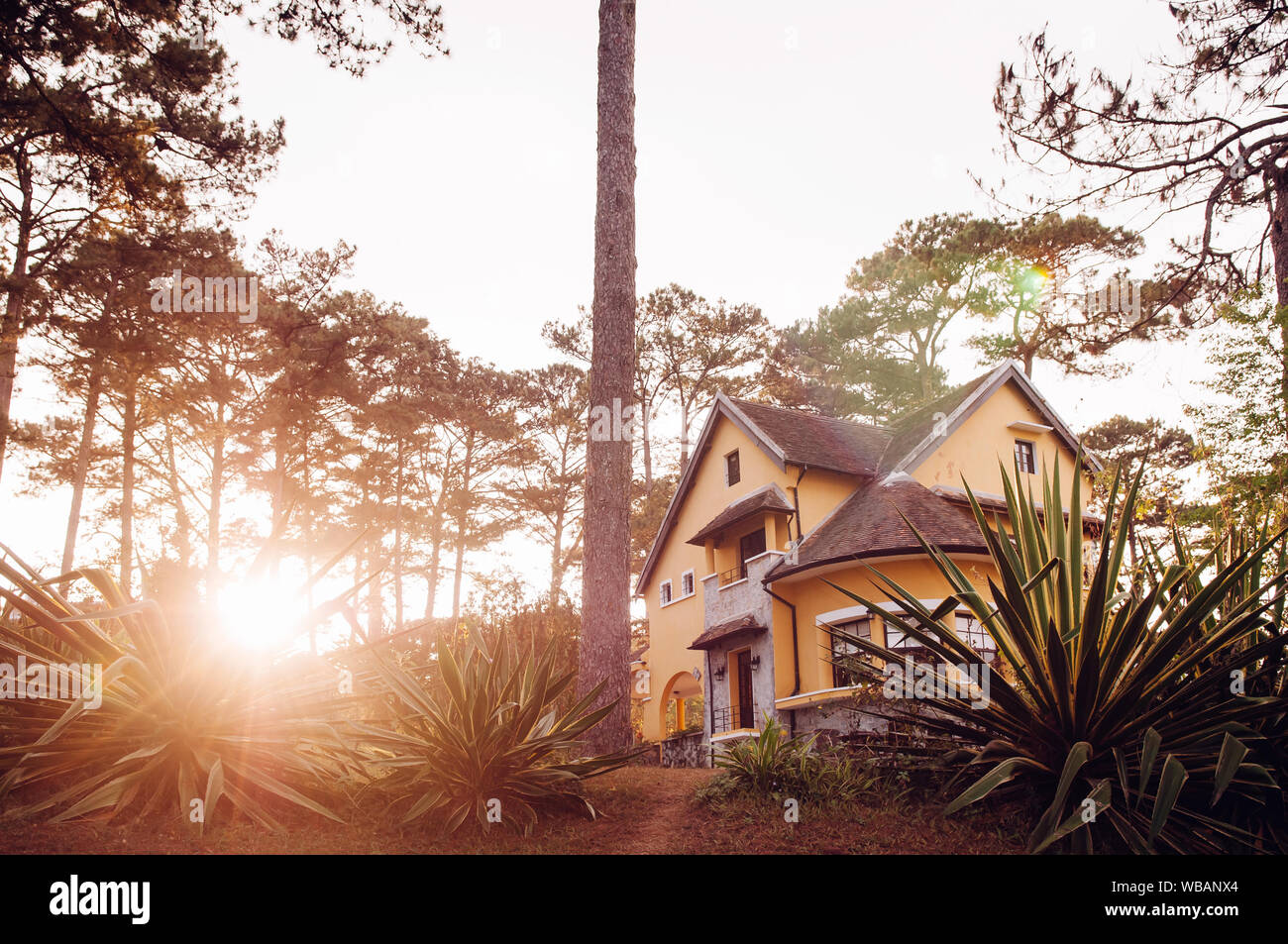 FEB 25, 2014 Dalat, Vietnam - Yellow vintage old French Colonial House under evening sun light ...