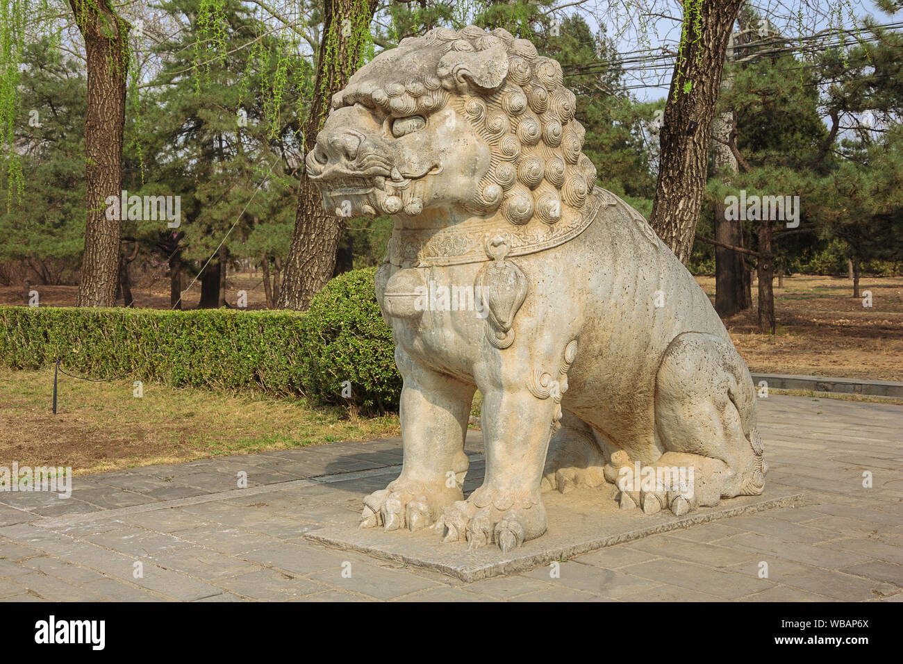 Statue of a sitting lion on the Sacred Road to the Ming Graves Stock ...