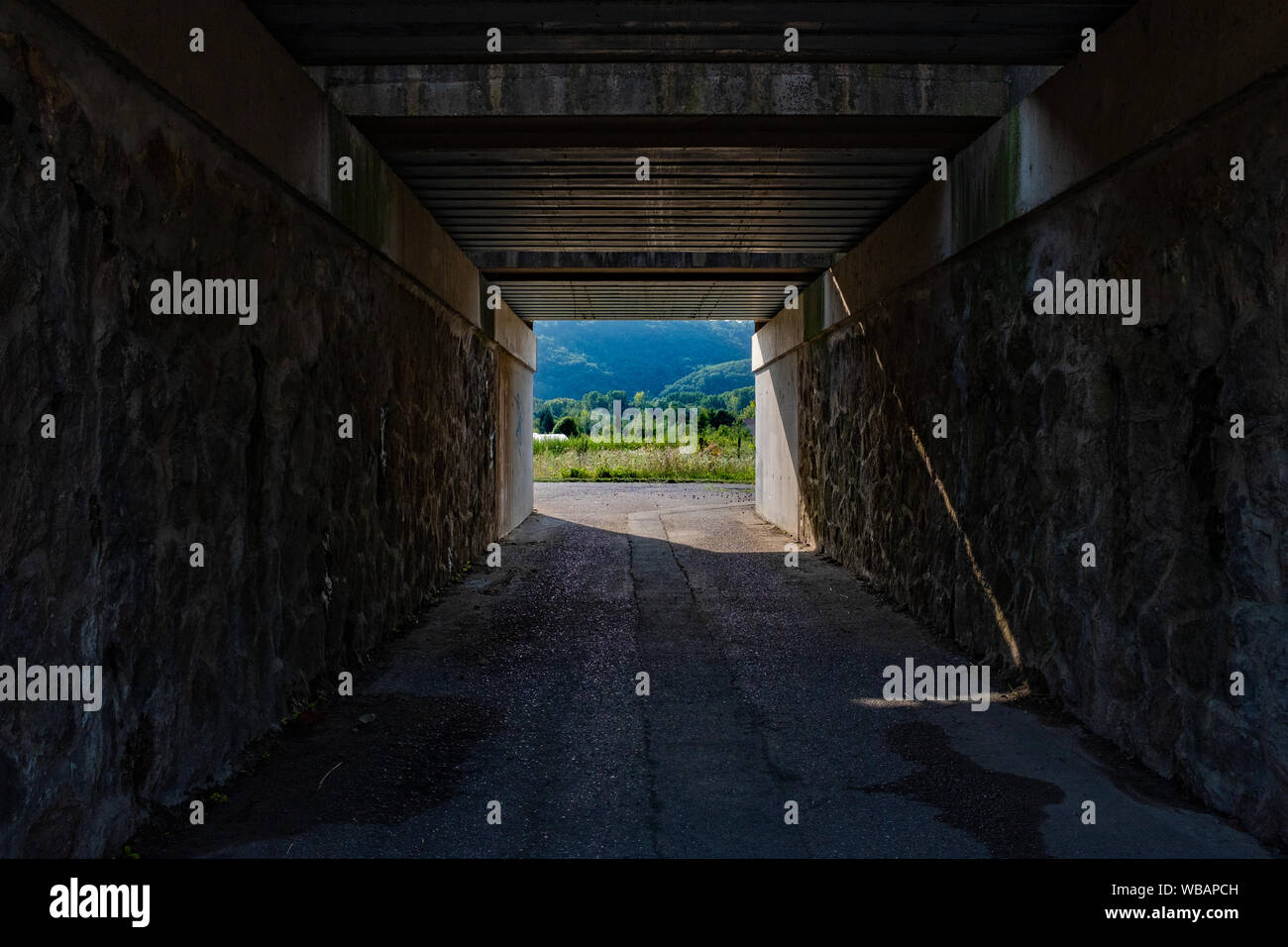 Rail over-bridge creating a slightly lit tunnel opening up to the ...