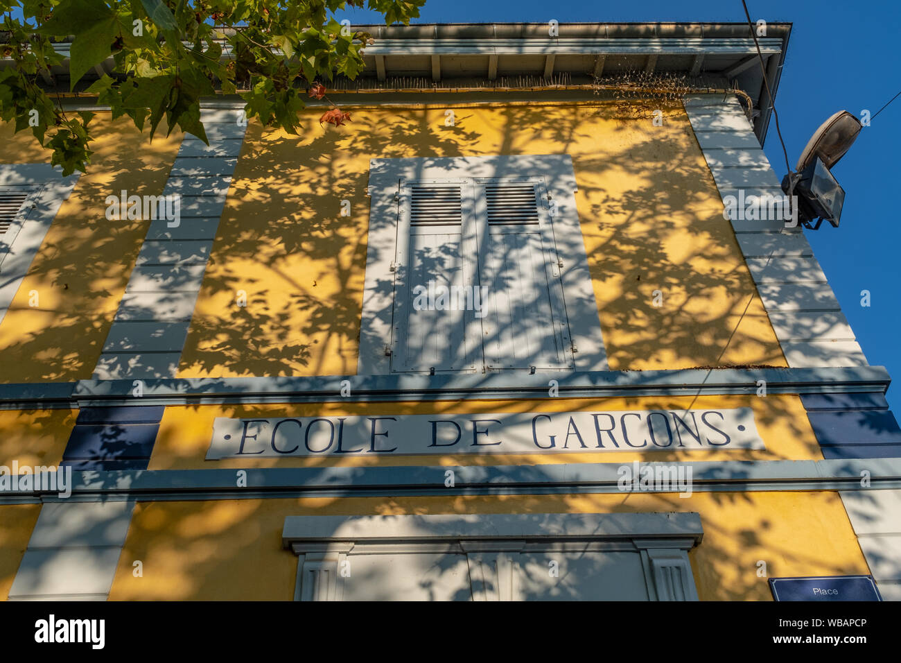 Yellow school facade on which it is written in French on top of one ...