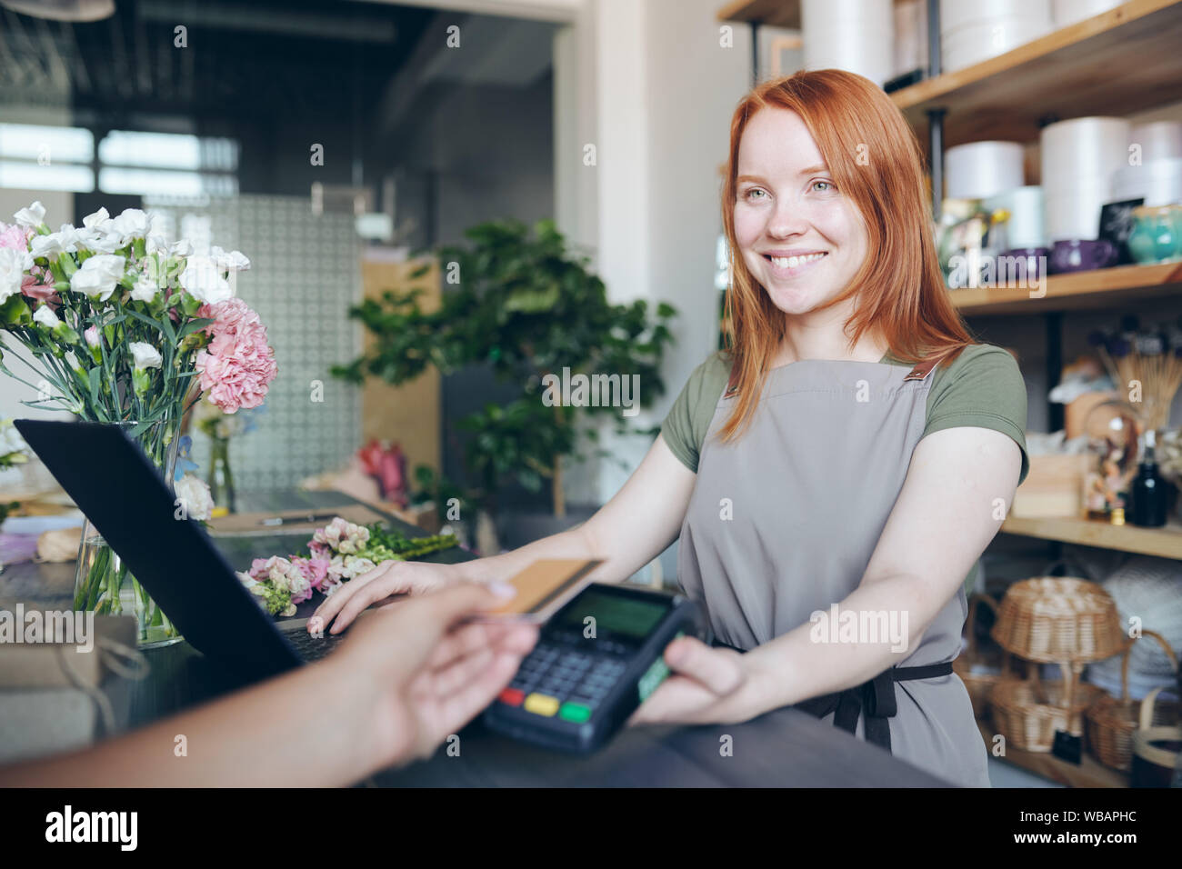 Girl selling flowers in shop Stock Photo - Alamy