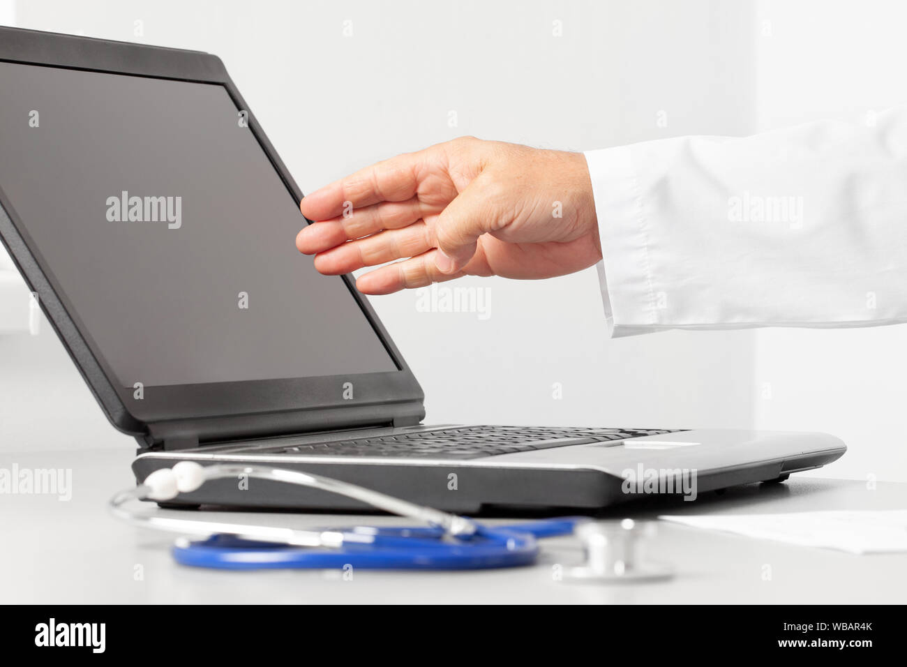 Doctor physician pointing showing by his hand the computer screen in ...