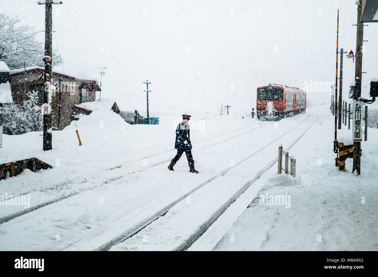 JAN 21, 2014 Aomori, Japan : Train conductor officer walk cross tracks ...
