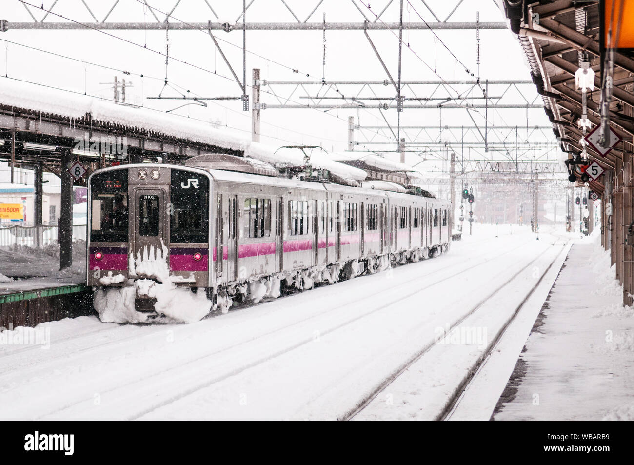 JAN 21, 2014 Hirosaki, Aomori, Japan : Pink strip JR East 701 Series ...