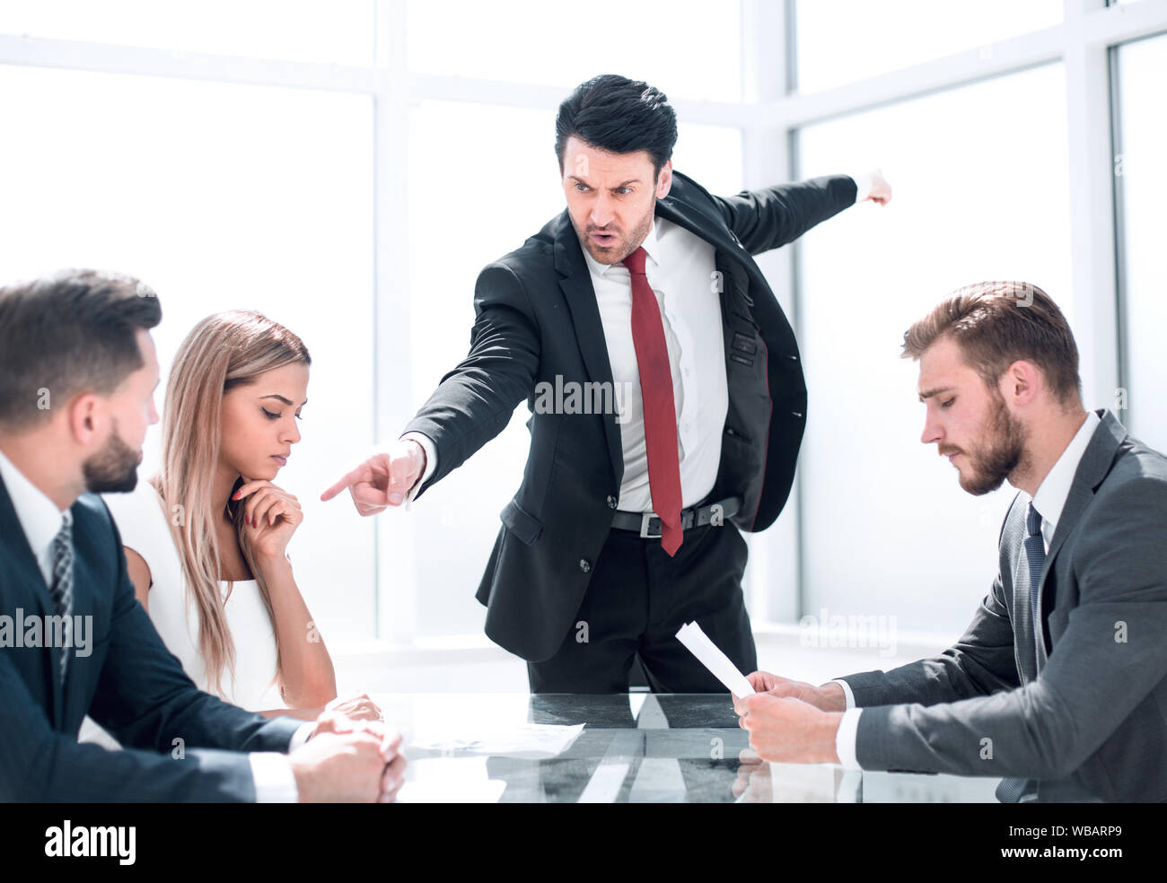 Strict boss telling upset female employee to leave meeting room Stock ...