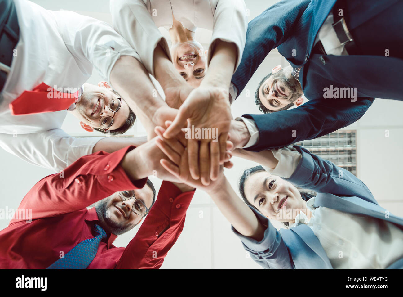 Team of diverse business people stacking their hands together Stock ...