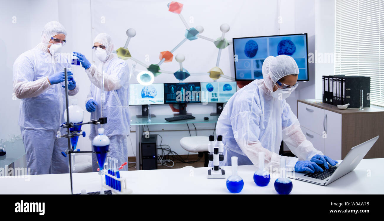 Team of scientist in protection equipment working in a modern research ...