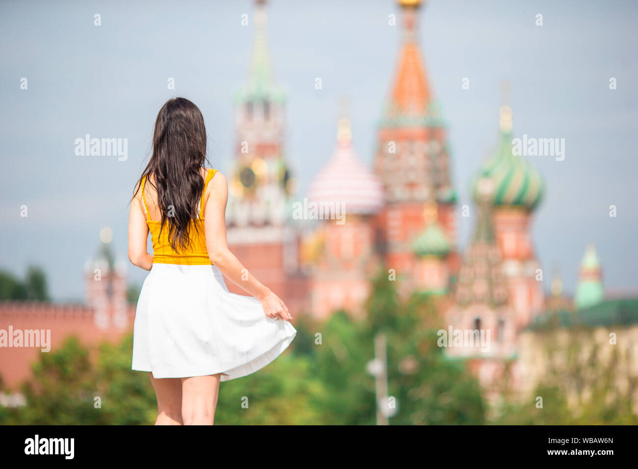 Happy young woman outdoors in Moscow city. Back view girl of Kremlin ...