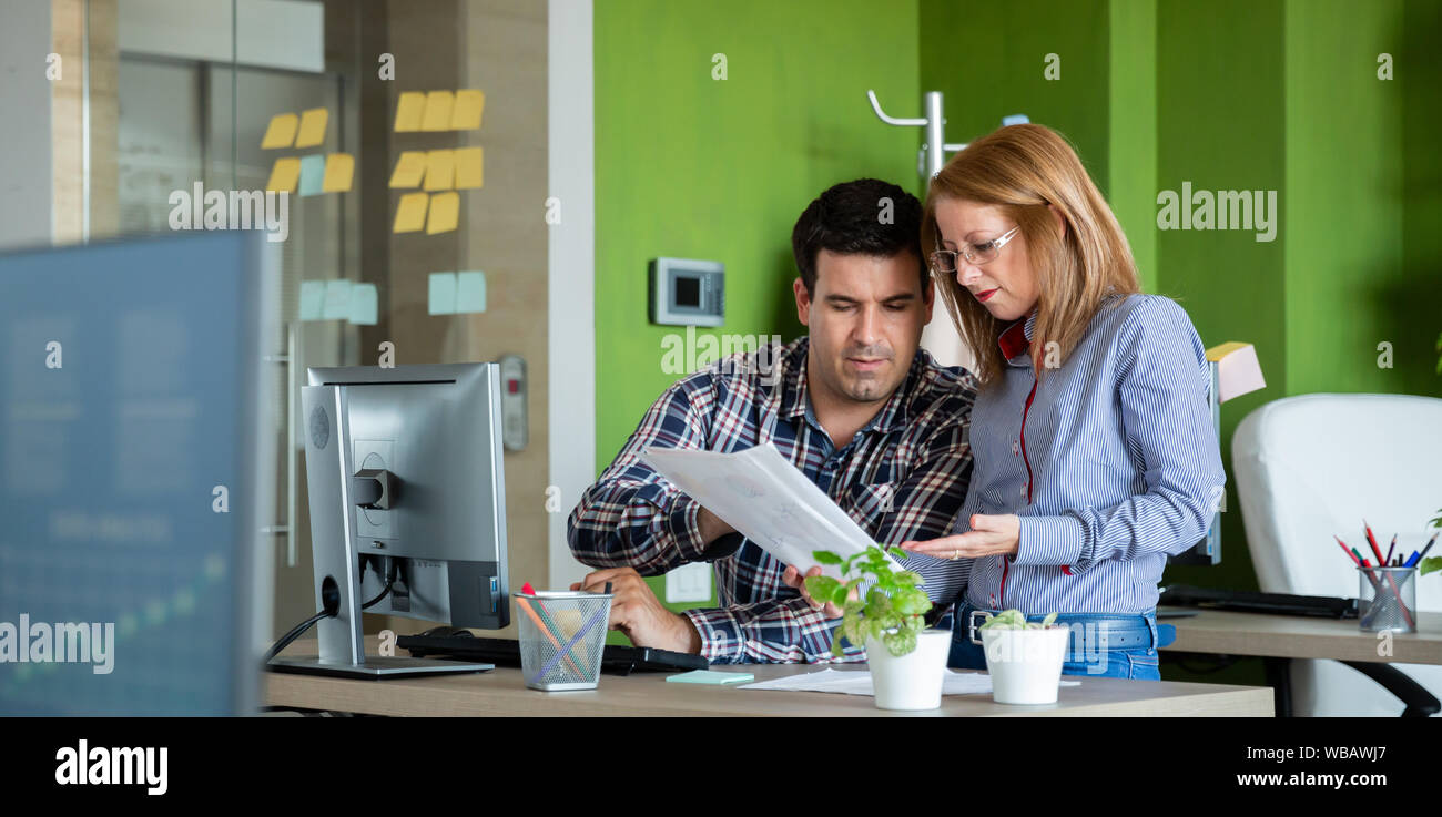 Two colleagues look over a chart. Annual report Stock Photo - Alamy