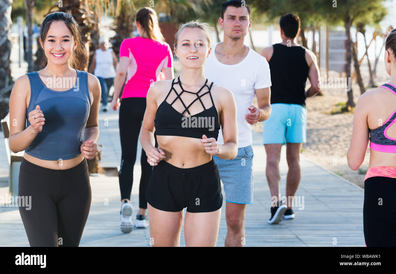 Active smiling people during running training in daytime Stock Photo ...