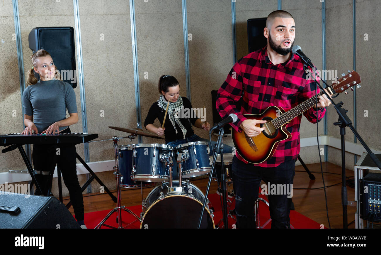 Rehearsal of music band. Happy cheerful positive smiling guy guitar ...