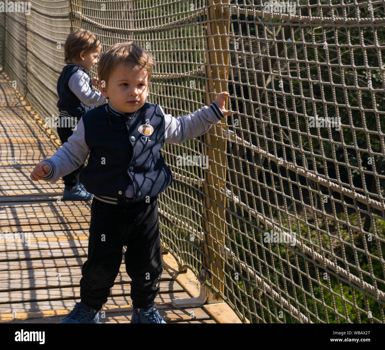 Child walking on the suspension bridge Stock Photo - Alamy