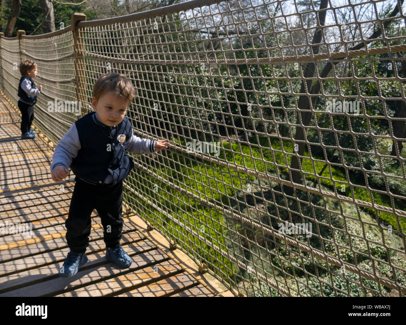 Child walking on the suspension bridge Stock Photo - Alamy