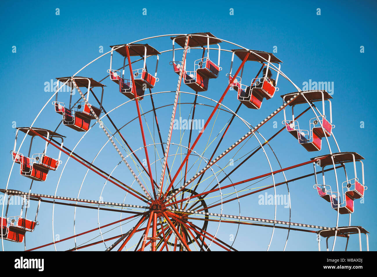 Big red carousel details and blue sky Stock Photo - Alamy