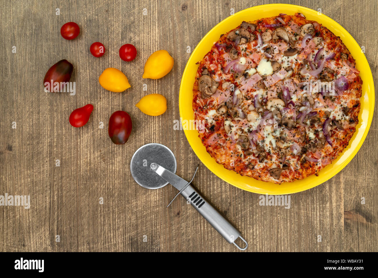 Delicious homemade pizza with pizza cutter . Top view Stock Photo - Alamy