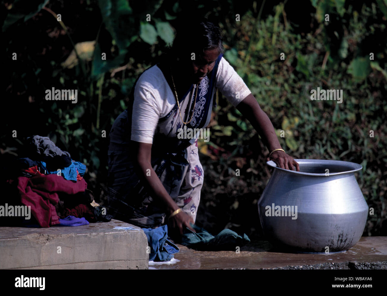 asia, asian india native indian cleaning a large utensil container ...