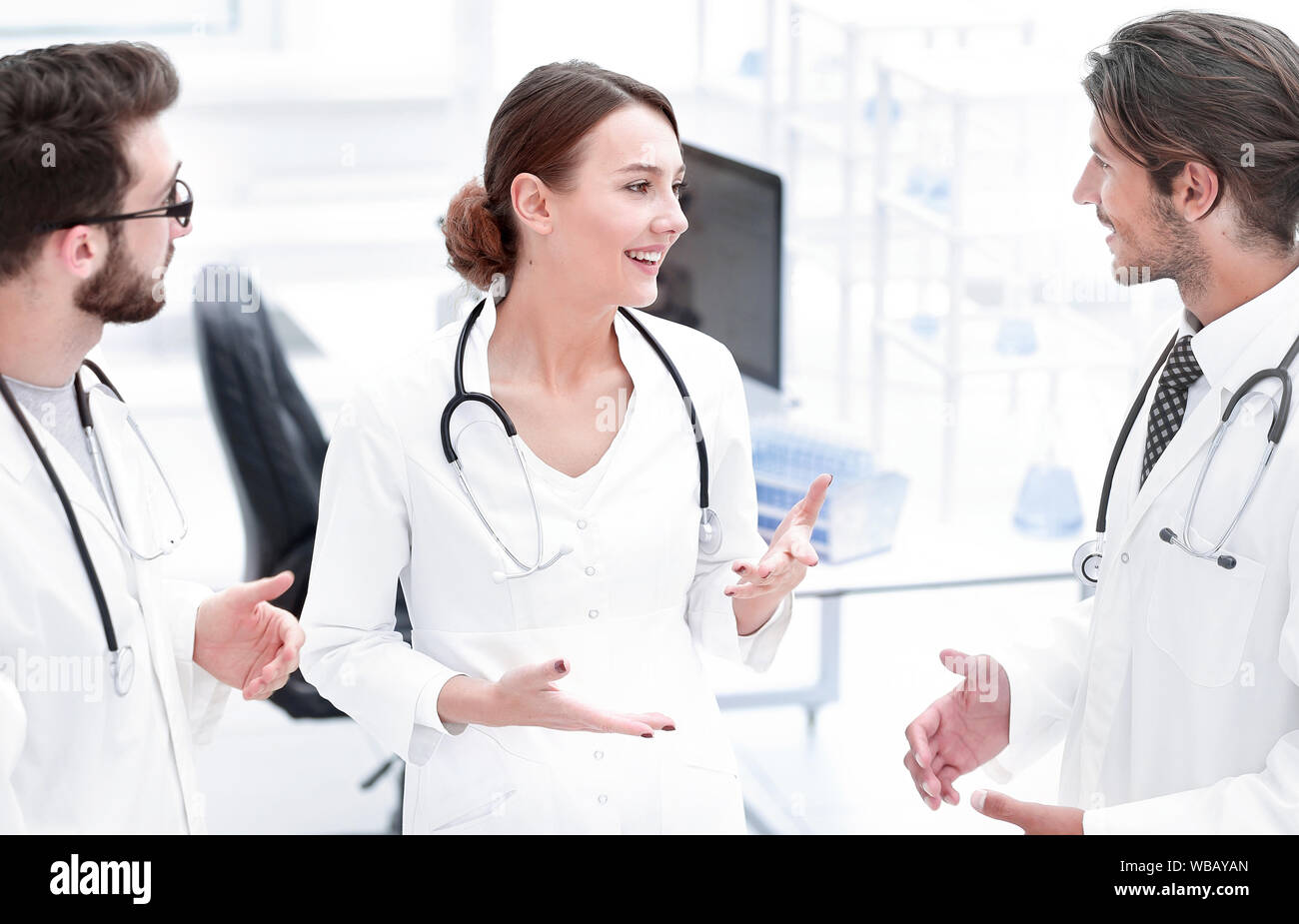 Team of different doctors having conversation Stock Photo - Alamy