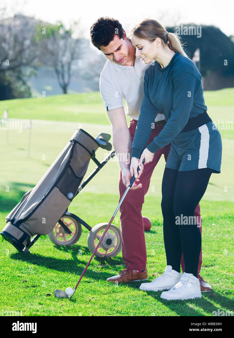 Golf Coach helping a young girl prepare for the game of golf Stock ...