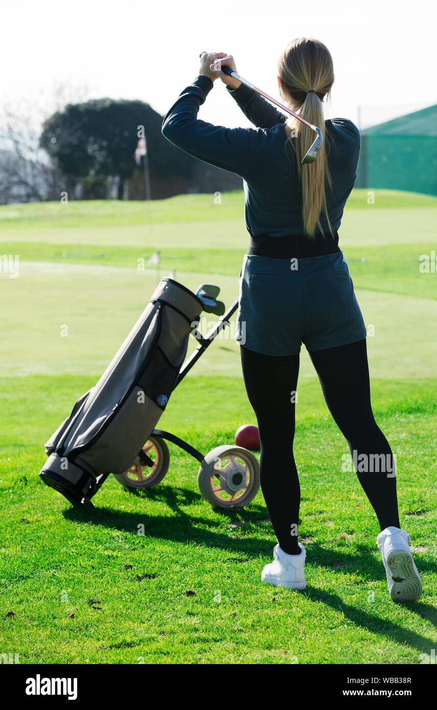 Female golfer made successful hit at golf course Stock Photo - Alamy