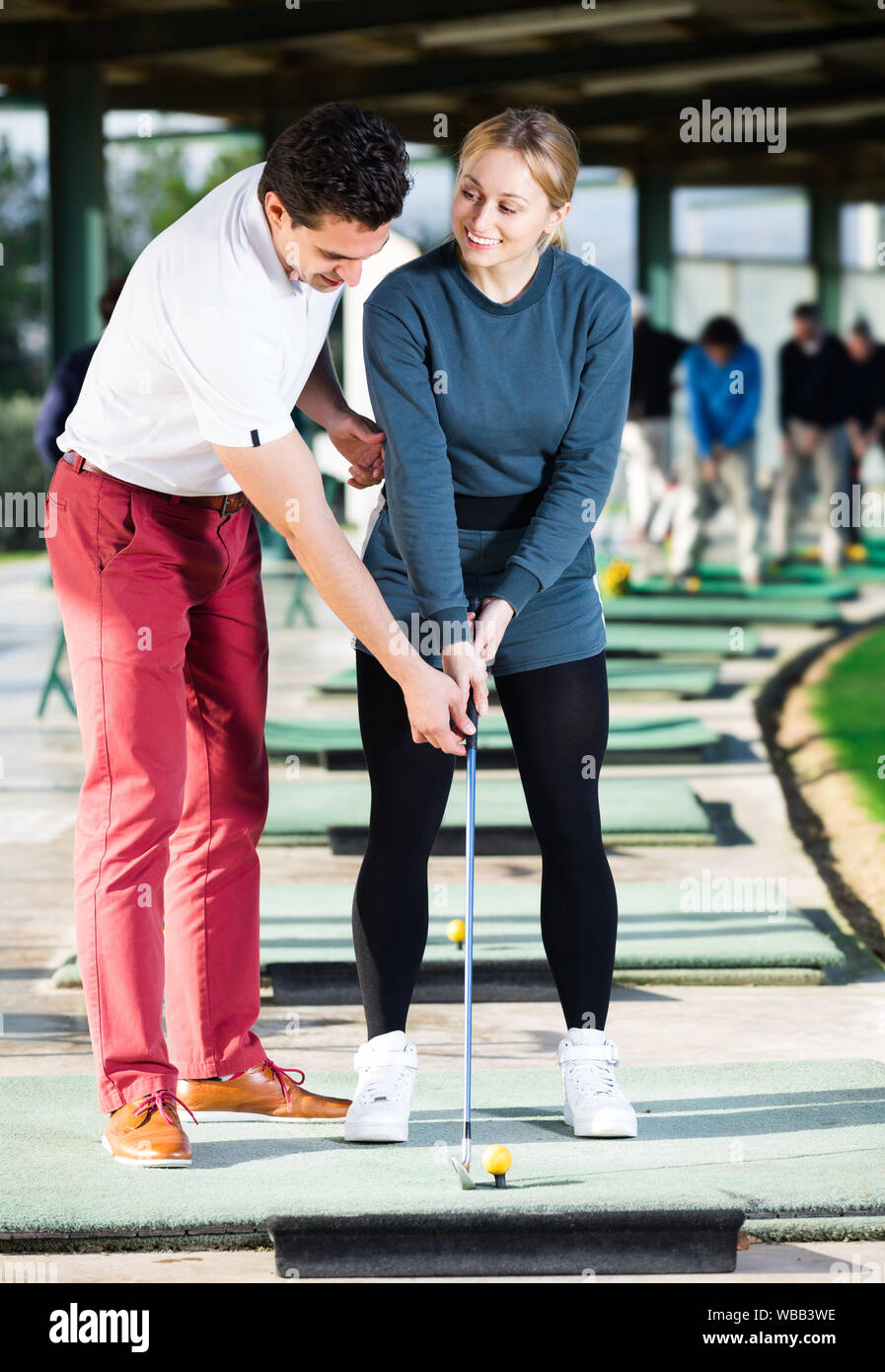 Sporty team are enjoying game at golf course together Stock Photo - Alamy