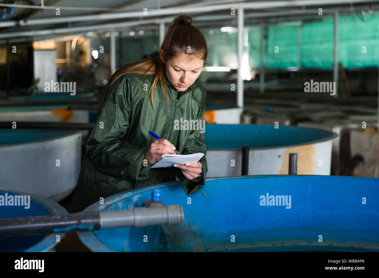 Portrait of woman fish farm worker at trout breeding incubator Stock ...