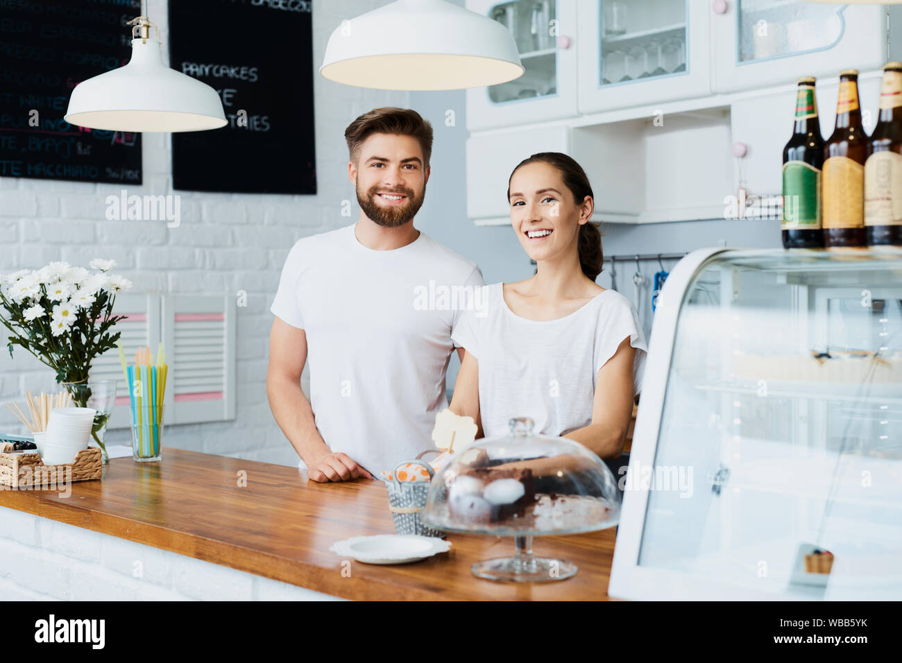 Two successful small business owners staring at camera and smiling ...