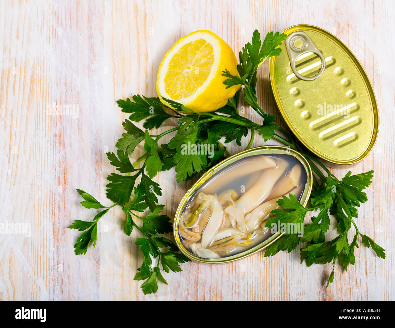 Seafood appetizer. Open can of preserved natural molluscs razorshell ...