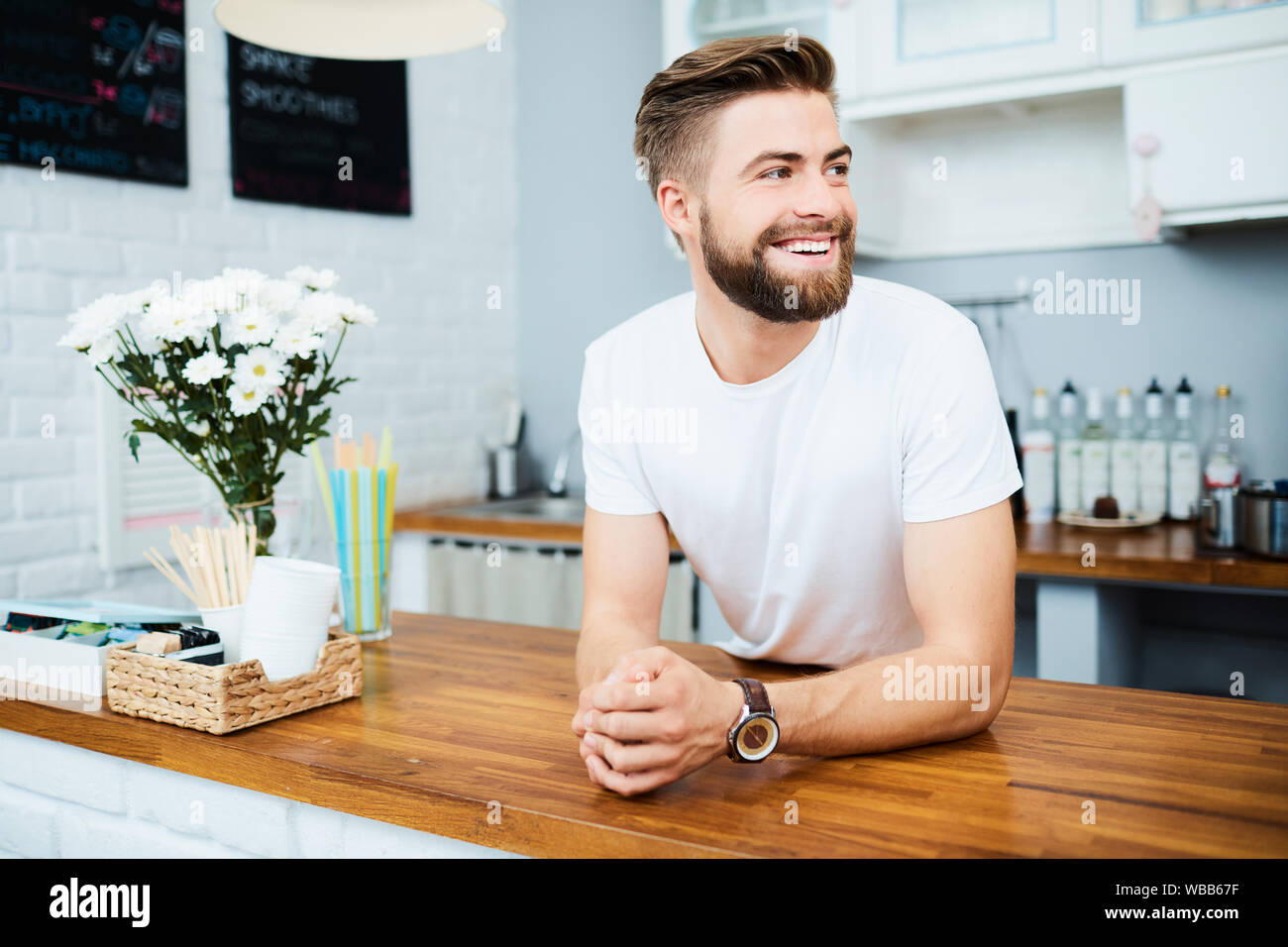 Handsome man leaning on counter hi-res stock photography and images - Alamy