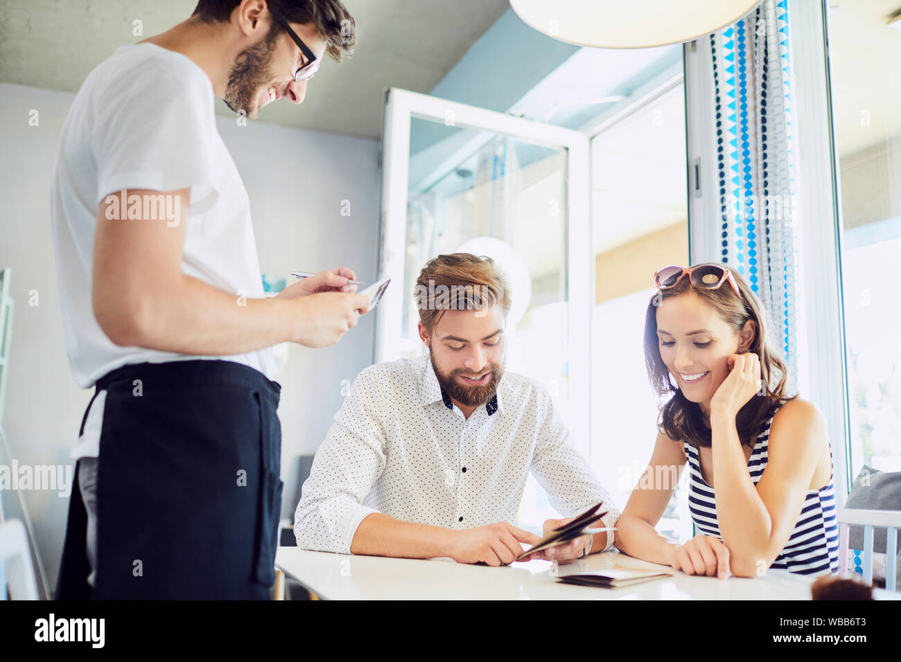 Young couple menu restaurant hi-res stock photography and images - Alamy