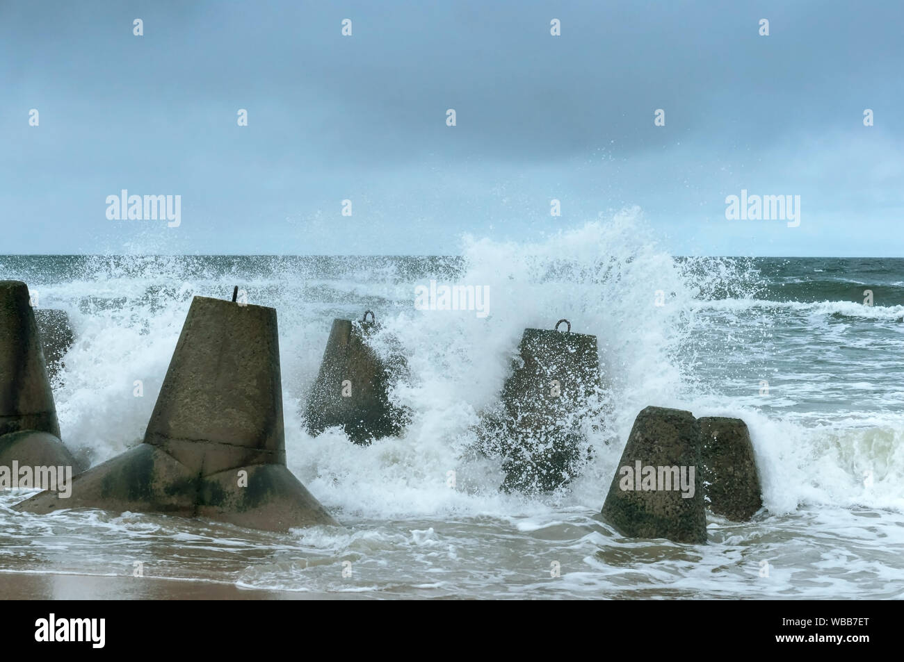 sea waves and breakwaters, storm on the sea and concrete coast ...
