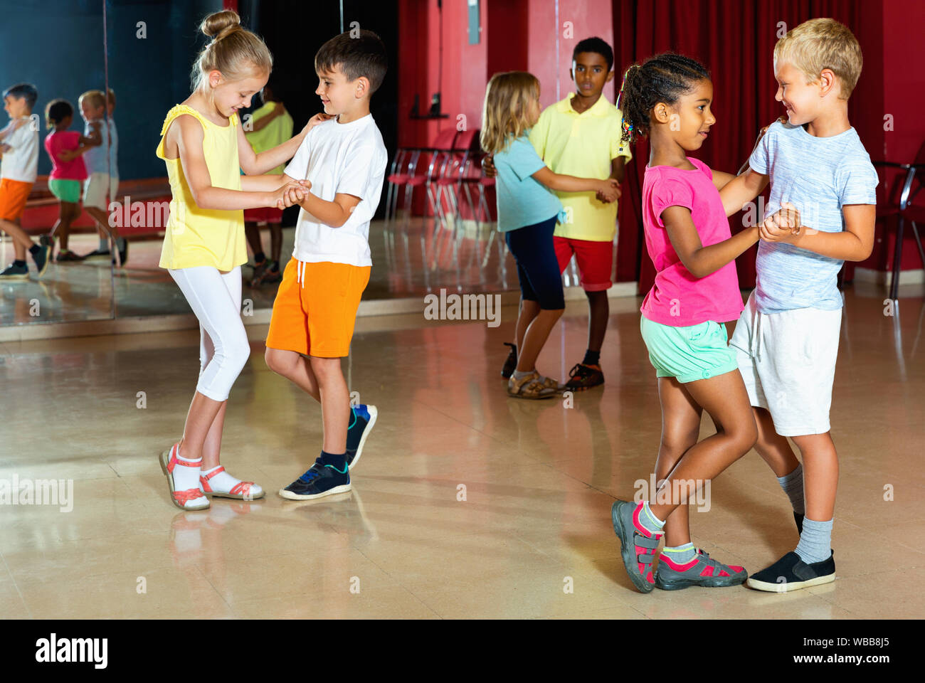 Group of happy positive smiling childrens trying dancing with partner ...