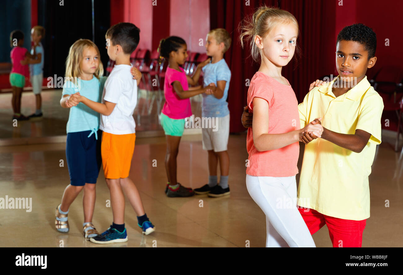 Group of glad smiling cheerful positive happy childrens trying dancing ...